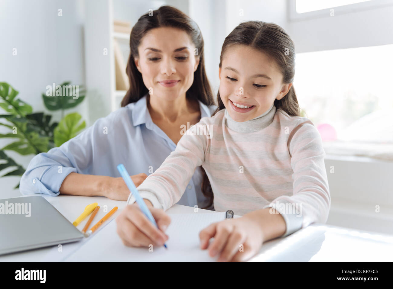 Cute intelligent girl taking notes Stock Photo - Alamy