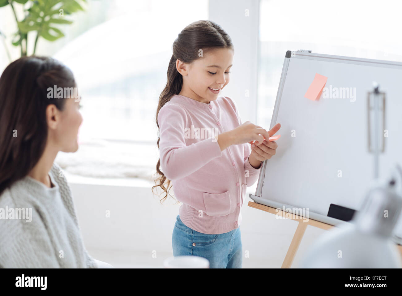 Positive smart girl holding sticky notes Stock Photo - Alamy