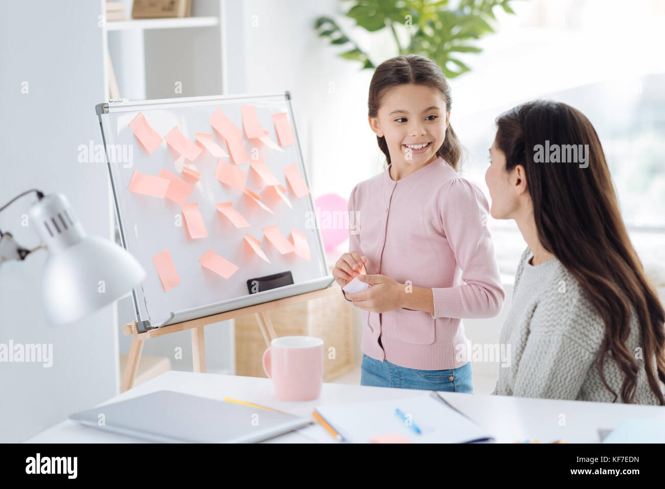 Positive cute girl preparing a project Stock Photo - Alamy