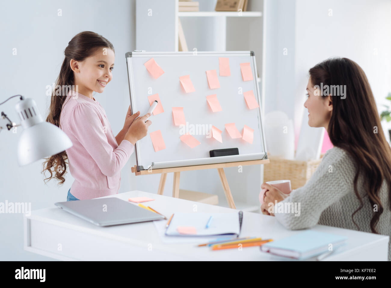 Positive nice girl pointing at the note Stock Photo - Alamy