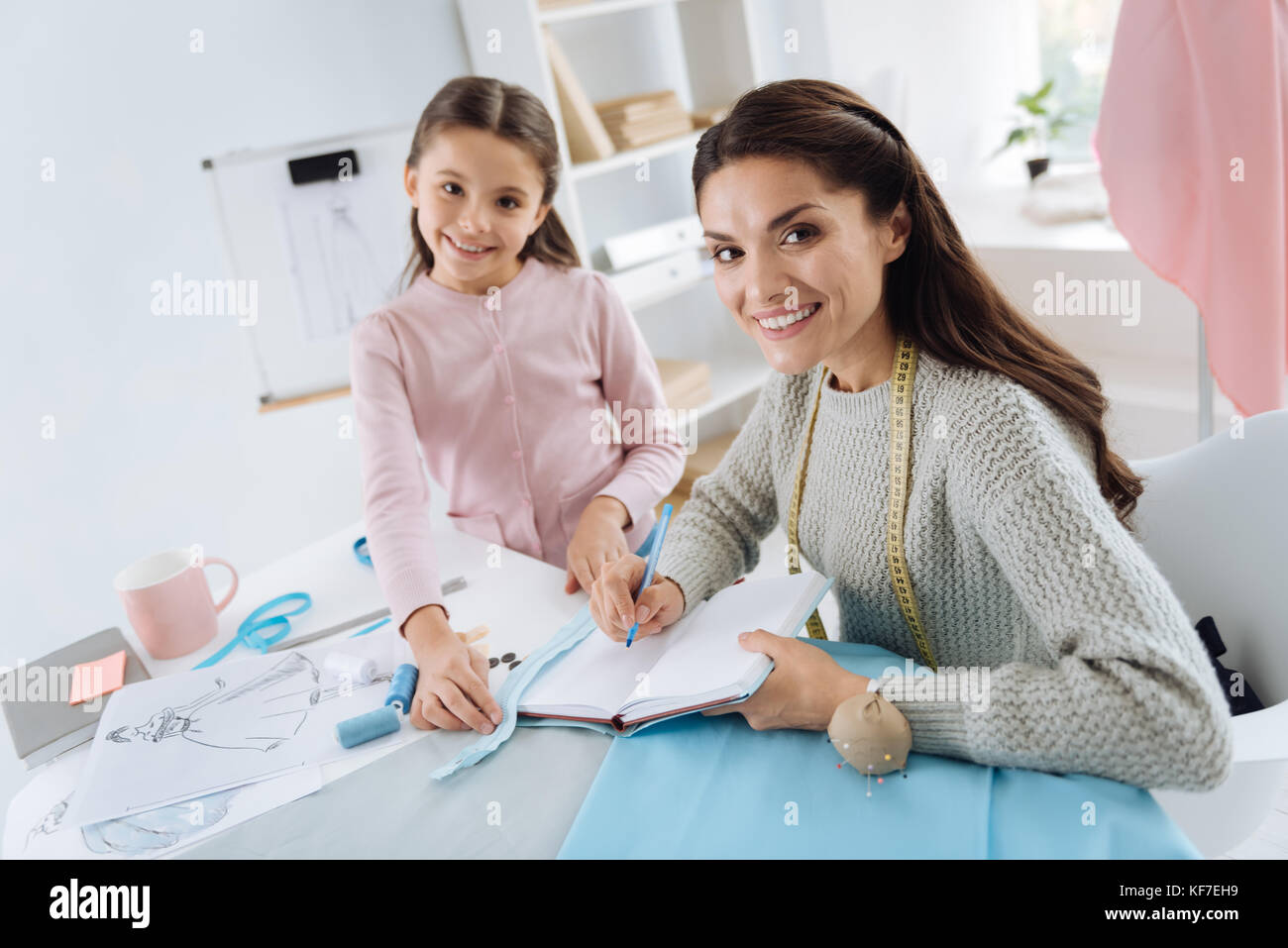 Happy smart woman writing in the notebook Stock Photo - Alamy