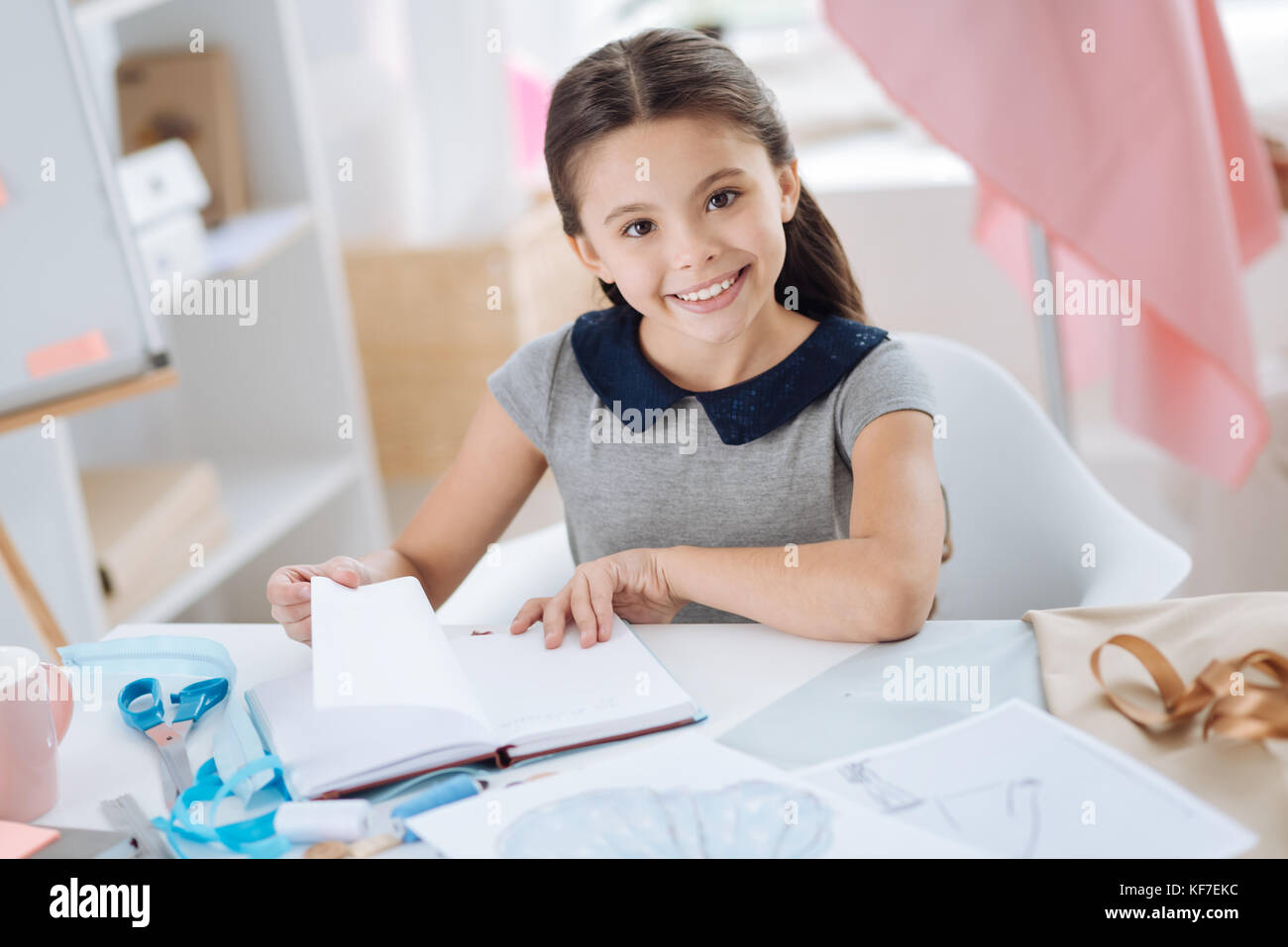 Positive creative girl working on clothes design Stock Photo - Alamy