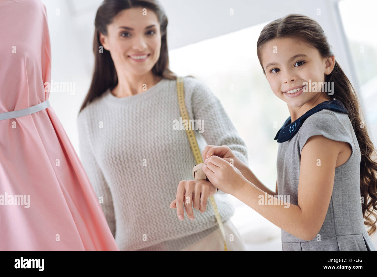 Cute young girl making a measurement of size Stock Photo - Alamy