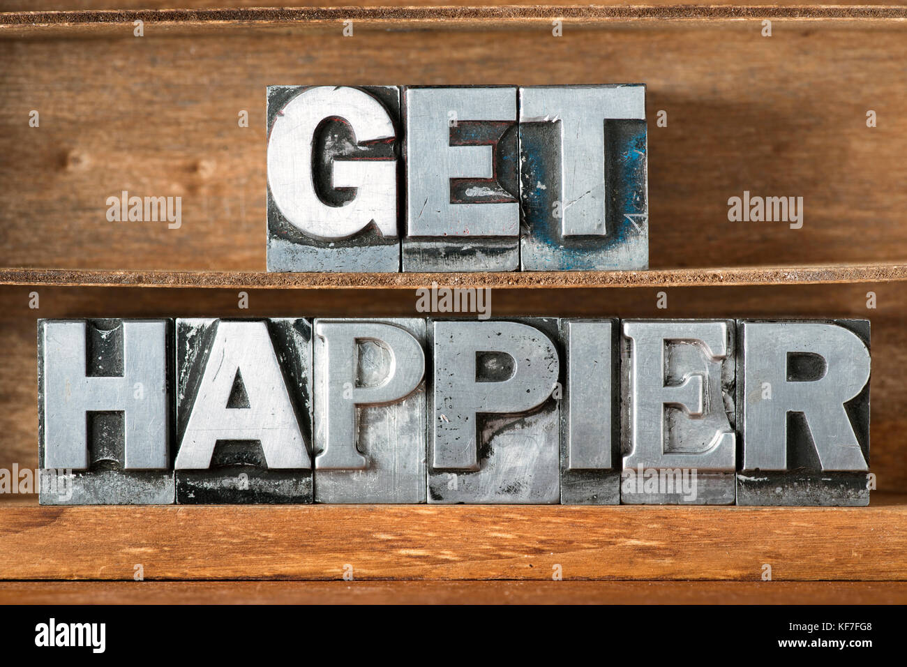get happier phrase made from metallic letterpress type on wooden tray ...