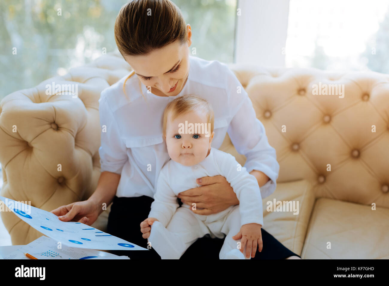 Loving mother looking kindly at the cute baby Stock Photo - Alamy
