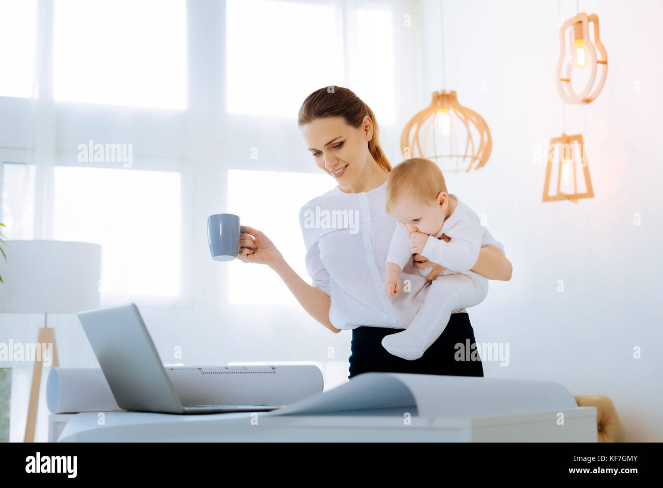 Peaceful morning of a talented engineer and her baby Stock Photo - Alamy