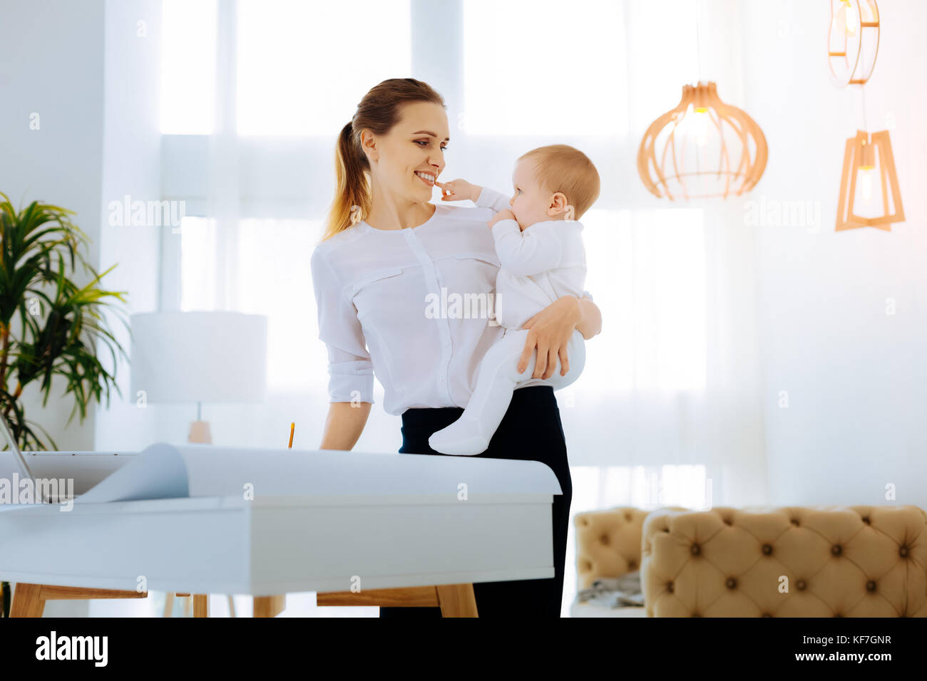 Cute baby touching the teeth of his mother Stock Photo - Alamy