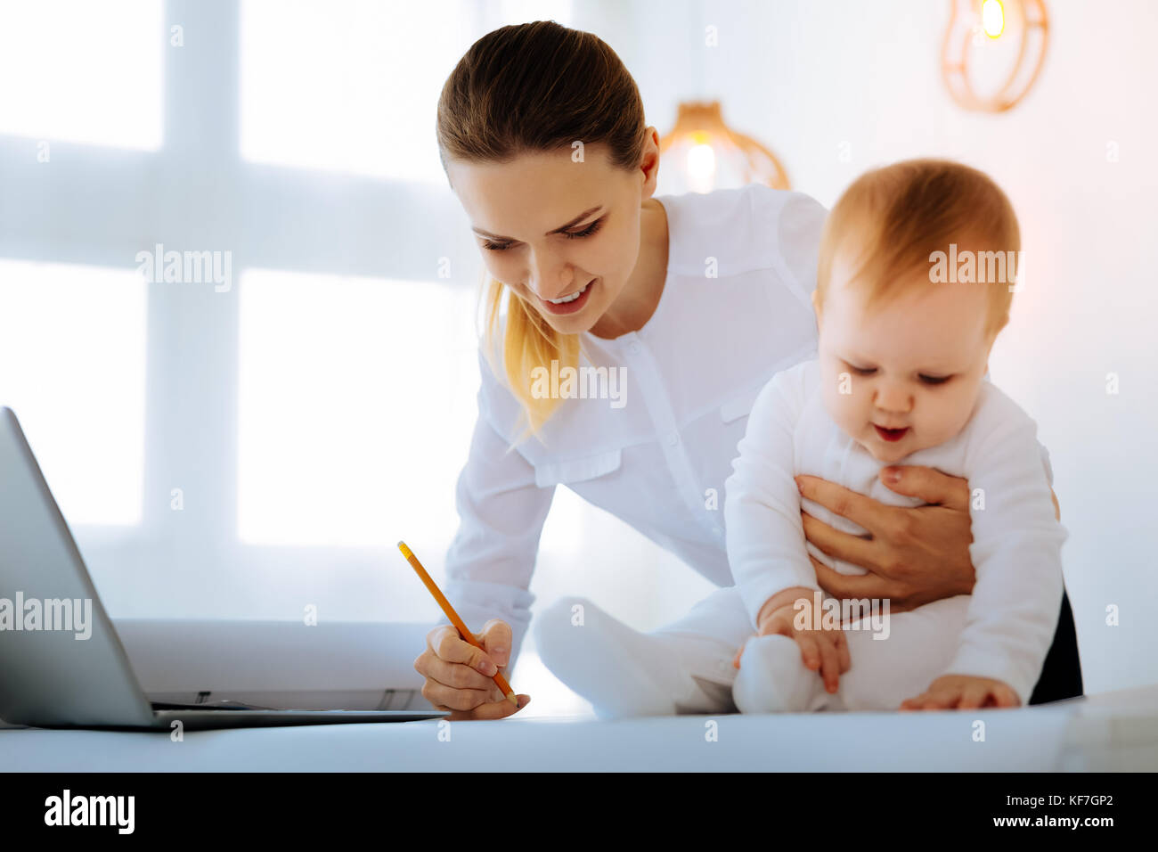 Attentive engineer working with a little baby Stock Photo - Alamy