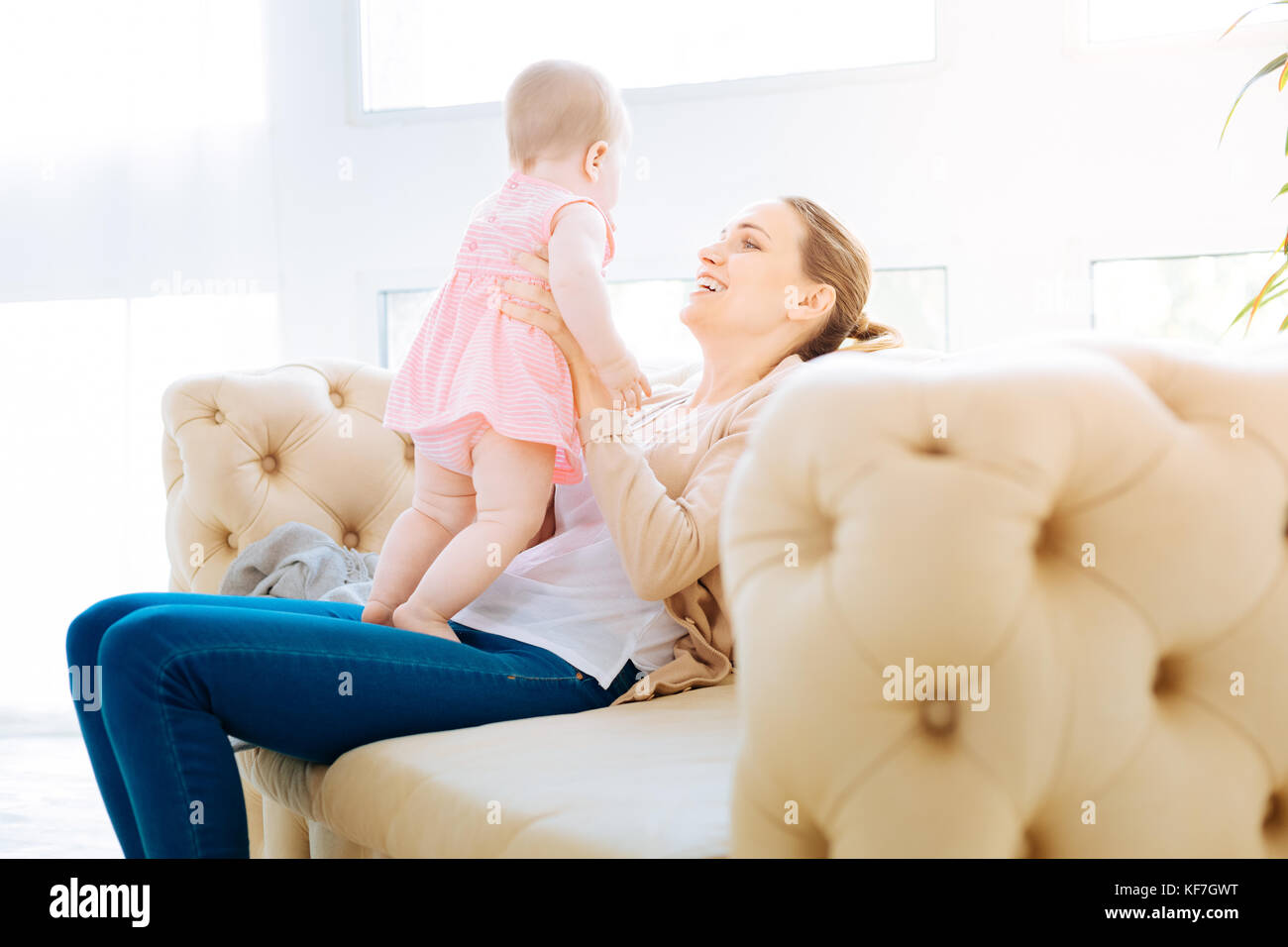 Delighted mother playing with a little child Stock Photo - Alamy