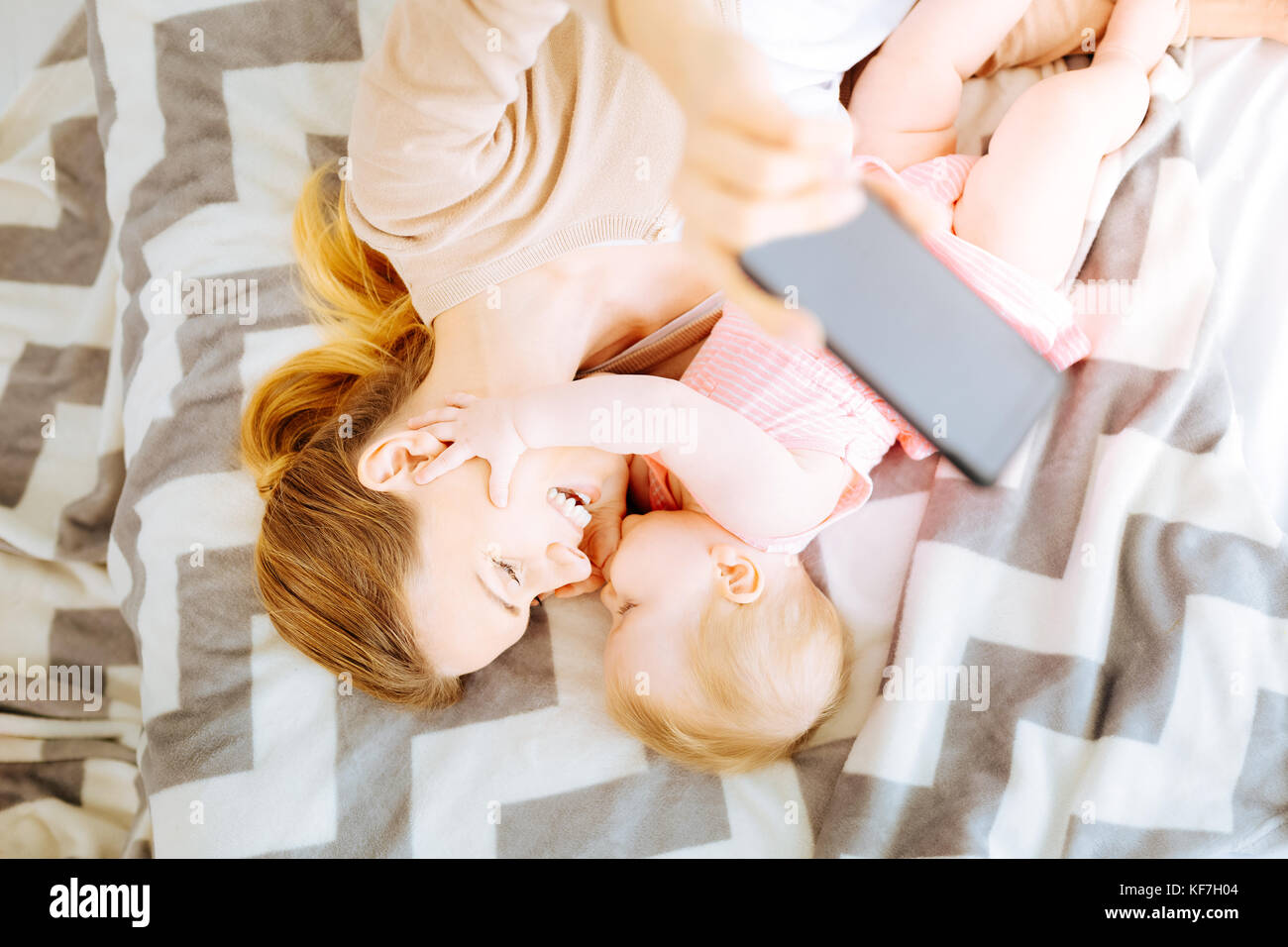 Cheerful mother hugging her little baby Stock Photo - Alamy