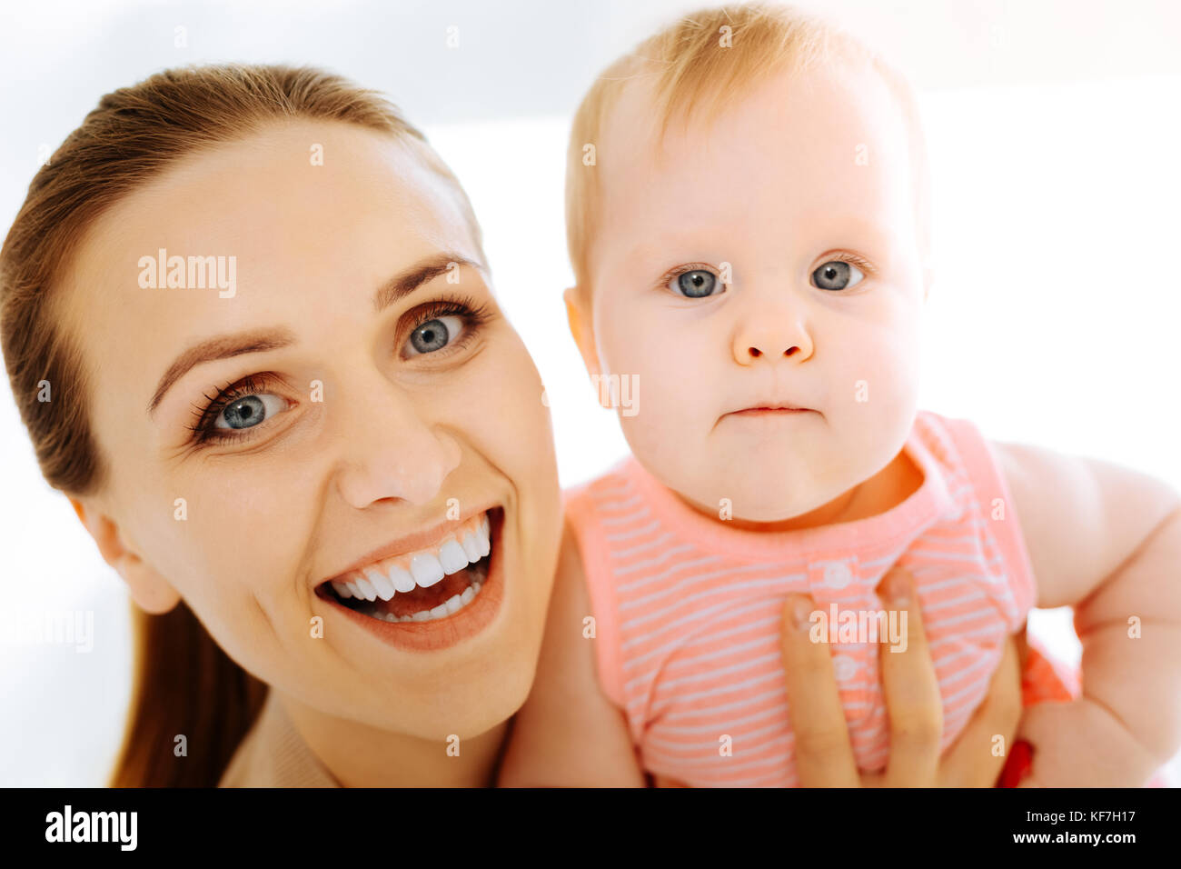 Emotional woman hugging a cute baby Stock Photo - Alamy