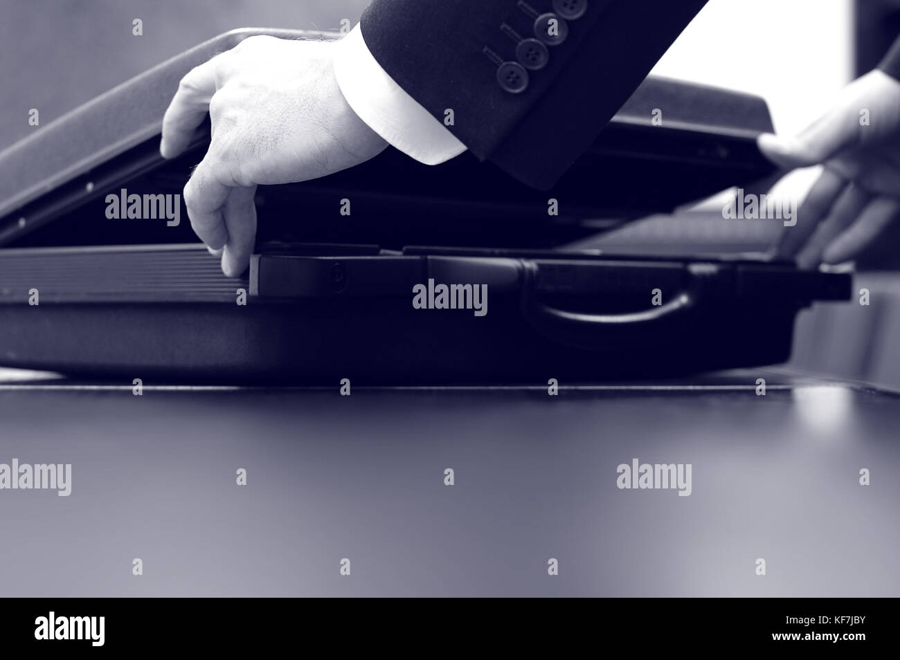 At the start of the business meeting, businessman opening briefcase ...