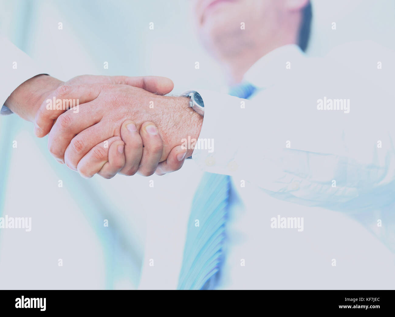 Low angle-shot of shake hands Stock Photo - Alamy