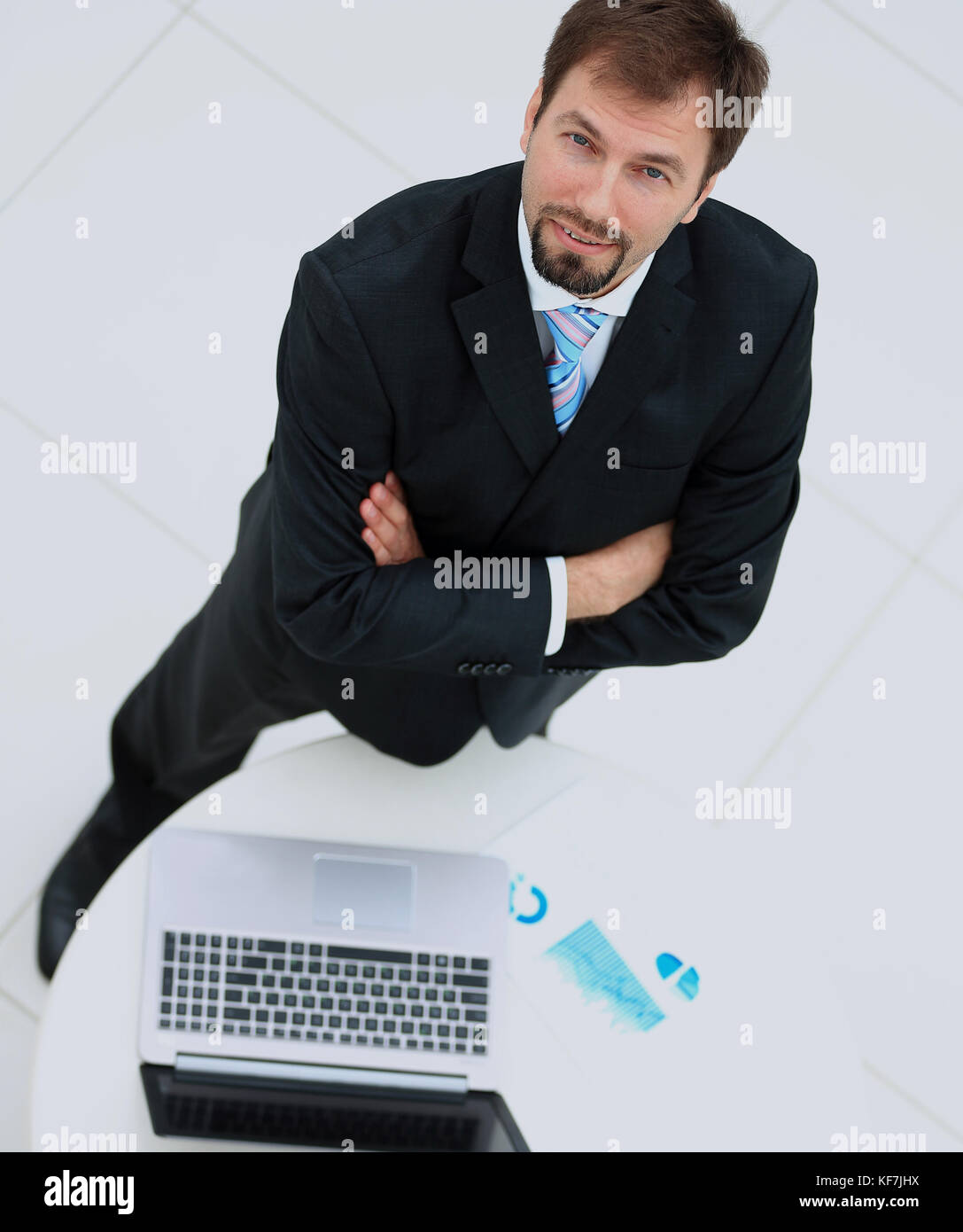 Portrait of a handsome elderly business man standing isolated on white ...