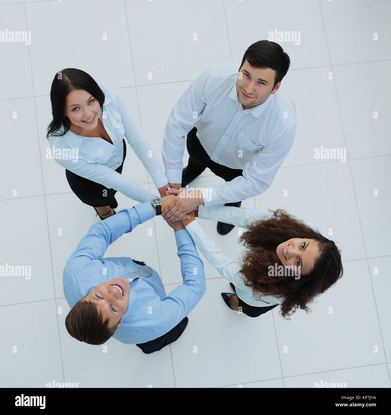 Business team showing unity with their hands together Stock Photo - Alamy