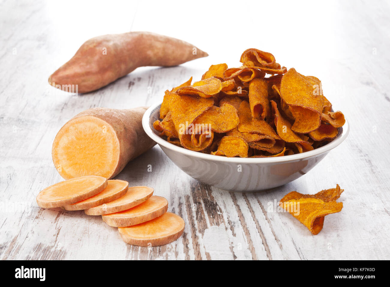 Batata chips in white cup isolated on white wooden background Stock ...