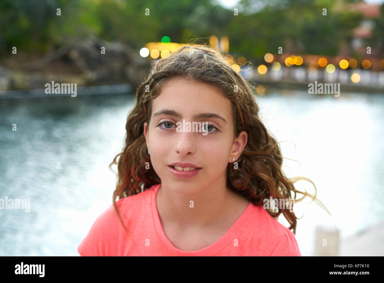 Blue eyes girl portrait at sunset with lights background in a lake ...