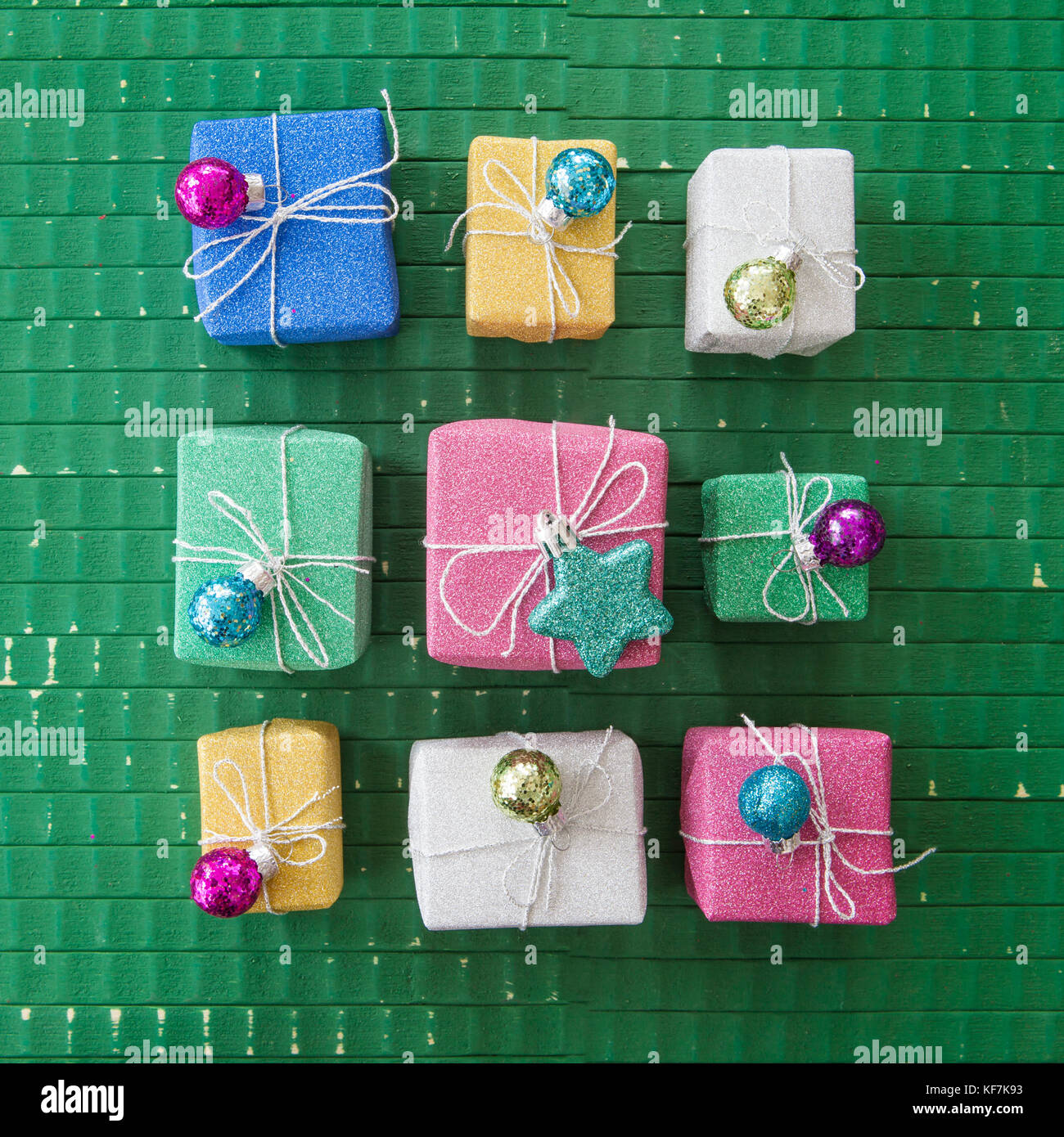 Little colorful gift boxes wrapped in glittery paper Stock Photo - Alamy