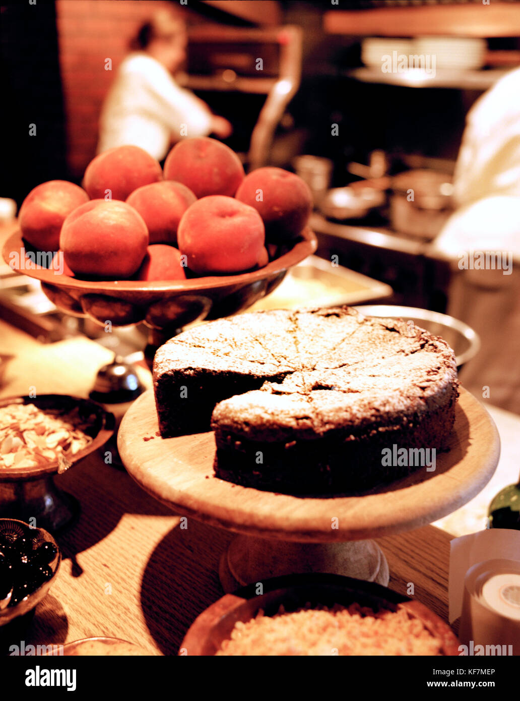 USA, California, Berkeley, chocolate cake with peaches in kitchen, Chez ...