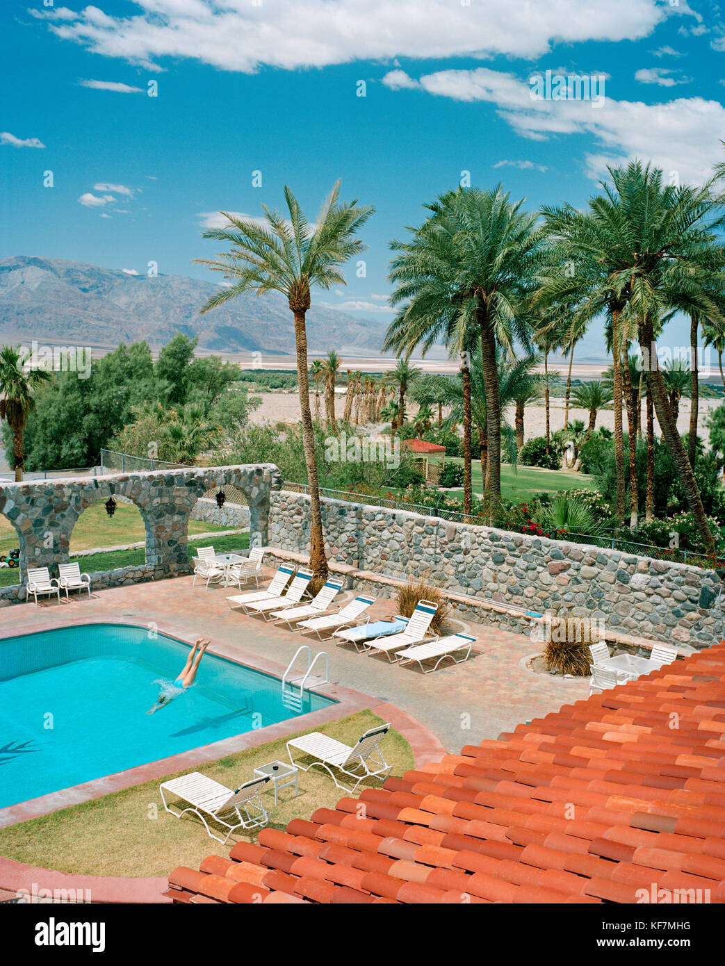 USA, California, Death Valley, woman diving in swimming pool, Furnace ...