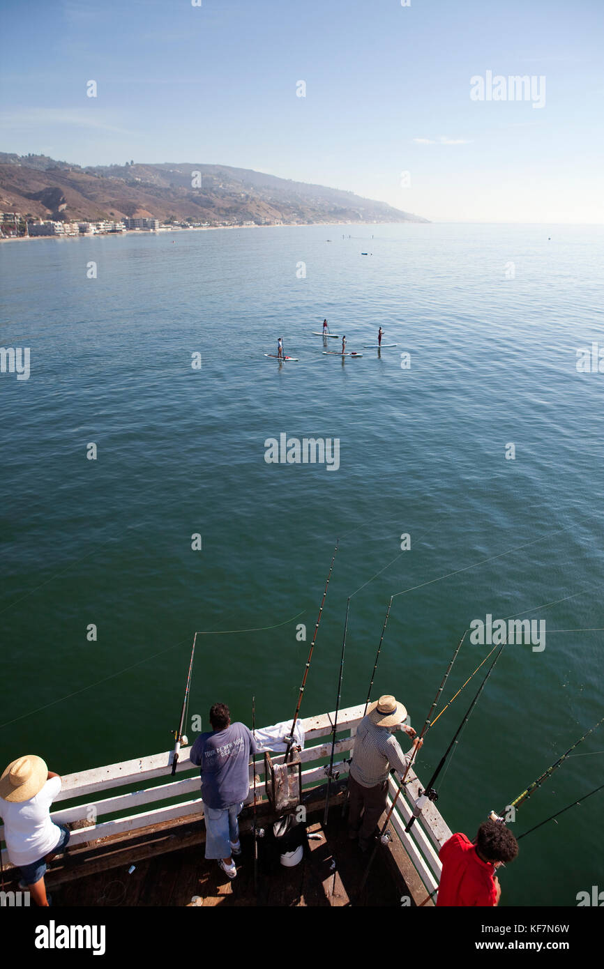 USA, California, Malibu, men fish off of the Malibu pier while four ...