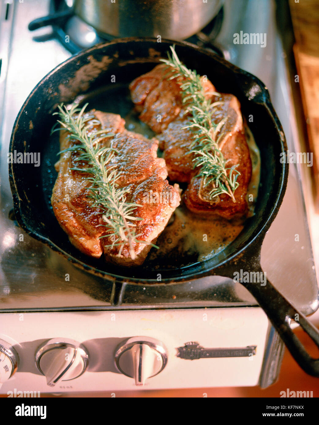 USA, California, Sonoma, pork being seared in a cast-iron pan, Brick ...
