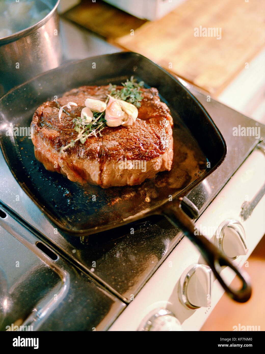 USA, California, Sonoma, pork being seared in a cast-iron pan, Brick ...