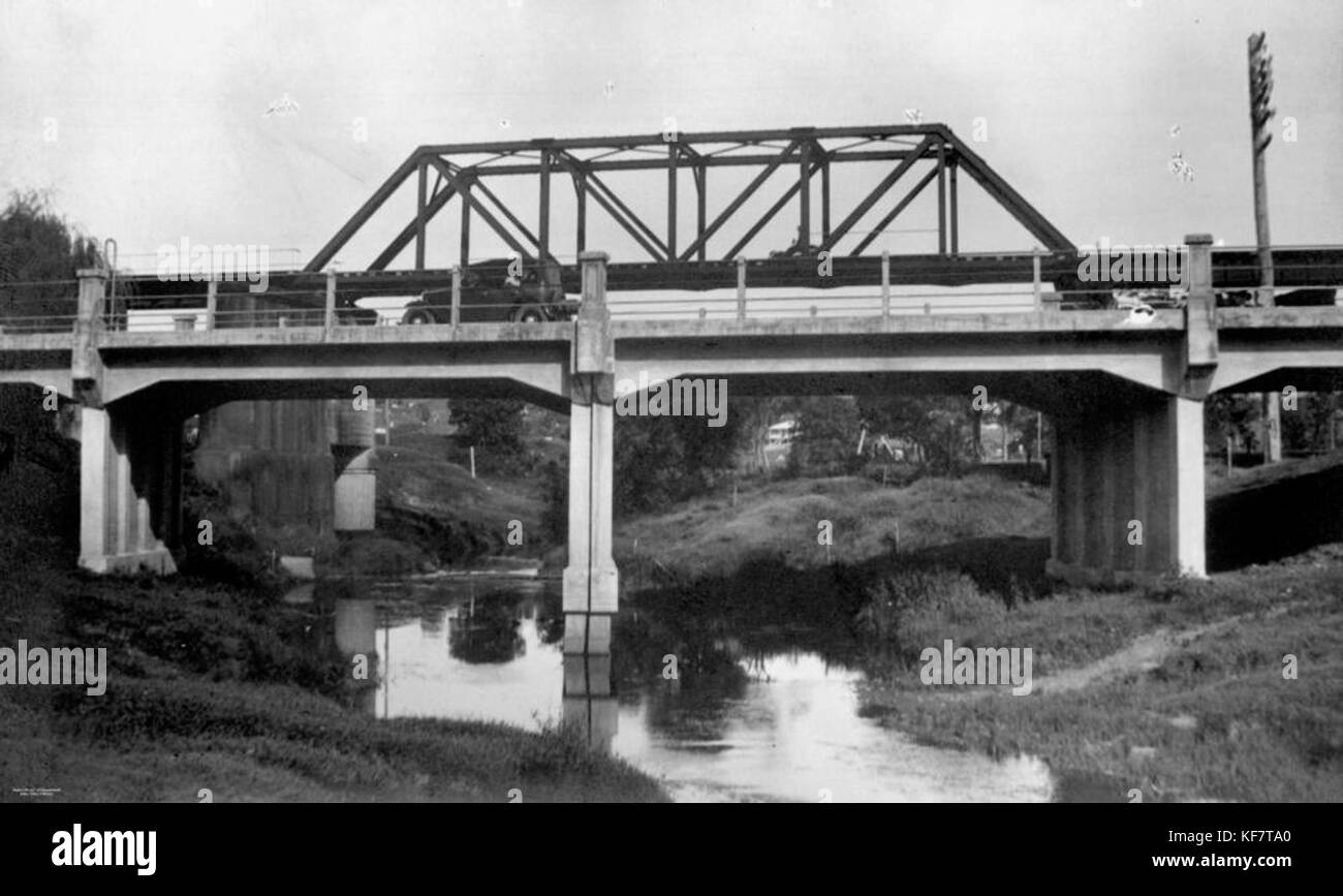 This historical image shows the traffic and railway bridges over Petrie ...
