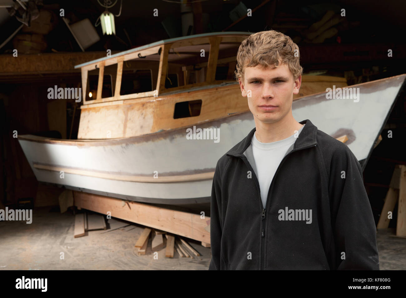 USA, Alaska, Homer, 16 year old Ben Fetterhoff stands in front of a 24 ...