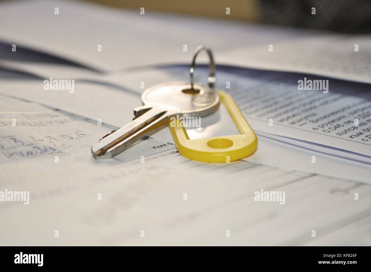 A key holder on pile of documents Stock Photo - Alamy