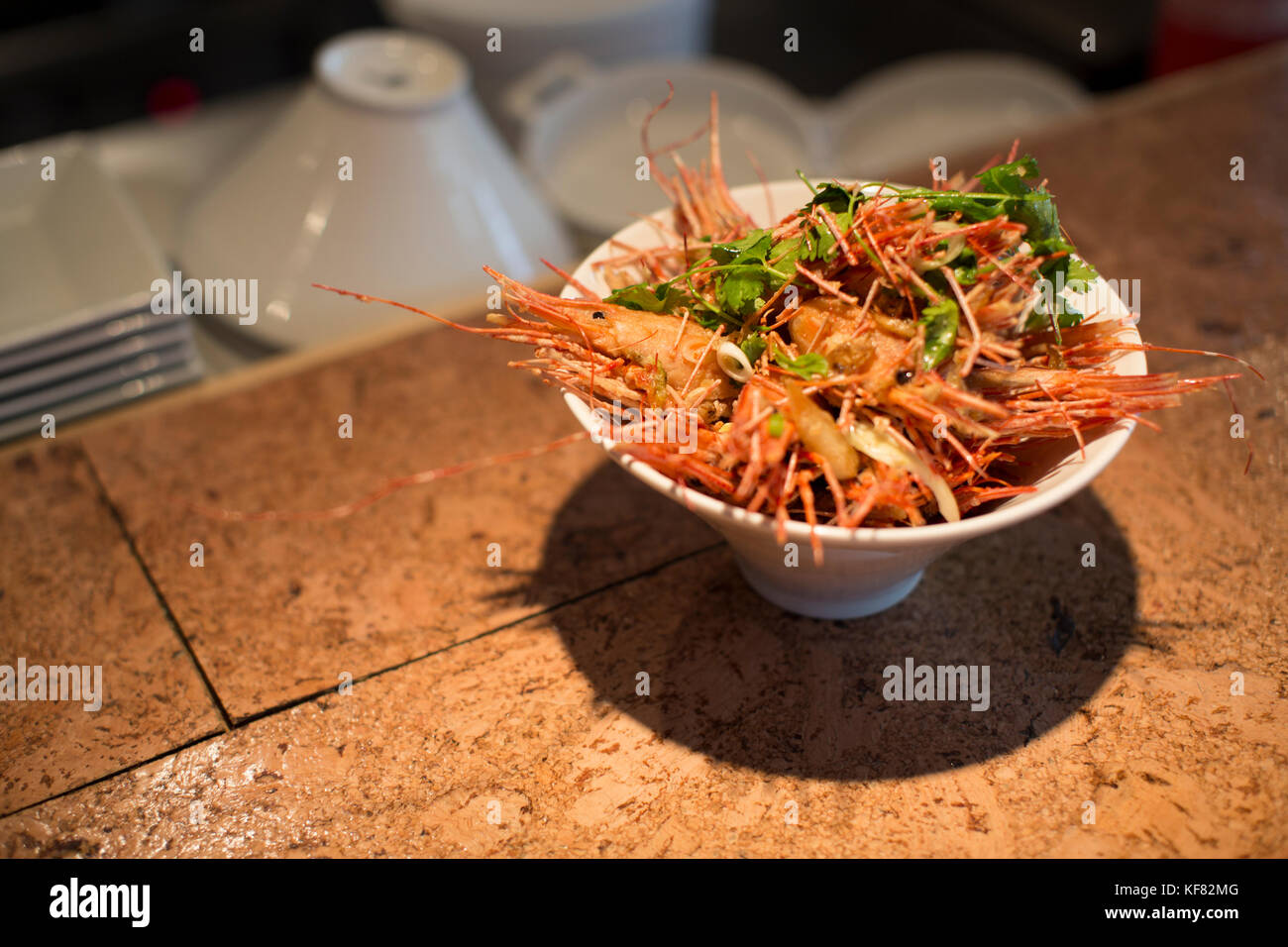 CANADA, Vancouver, British Columbia, a bowl of fried shrimp heads are ...