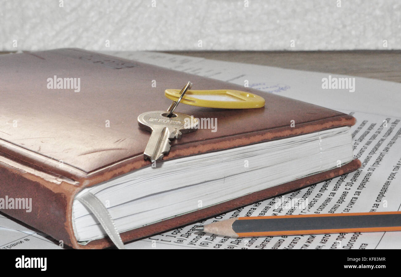 Business notebook with keys over documents Stock Photo - Alamy