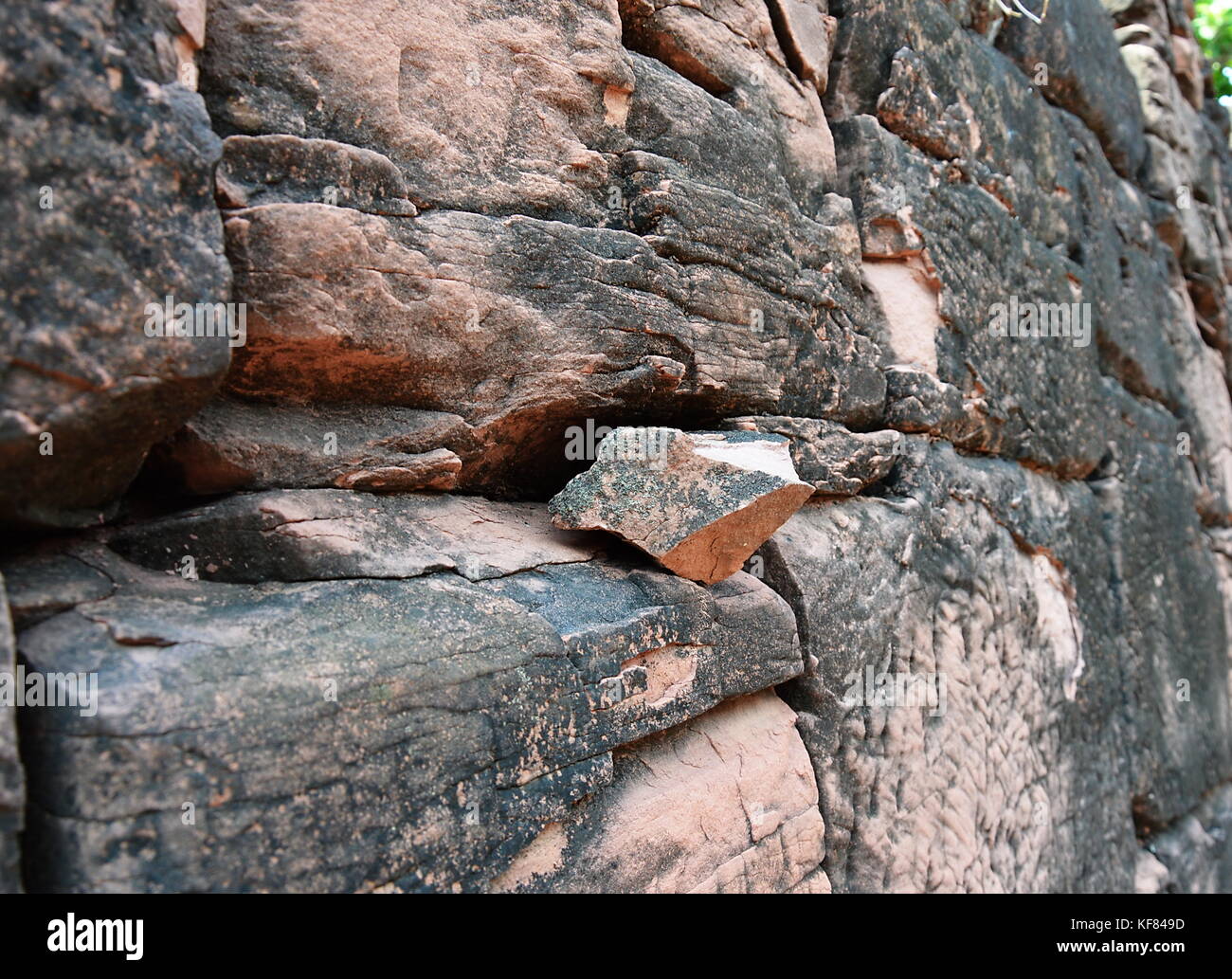 piece of triangle ancient rock on the wall at Phimai historical park ...