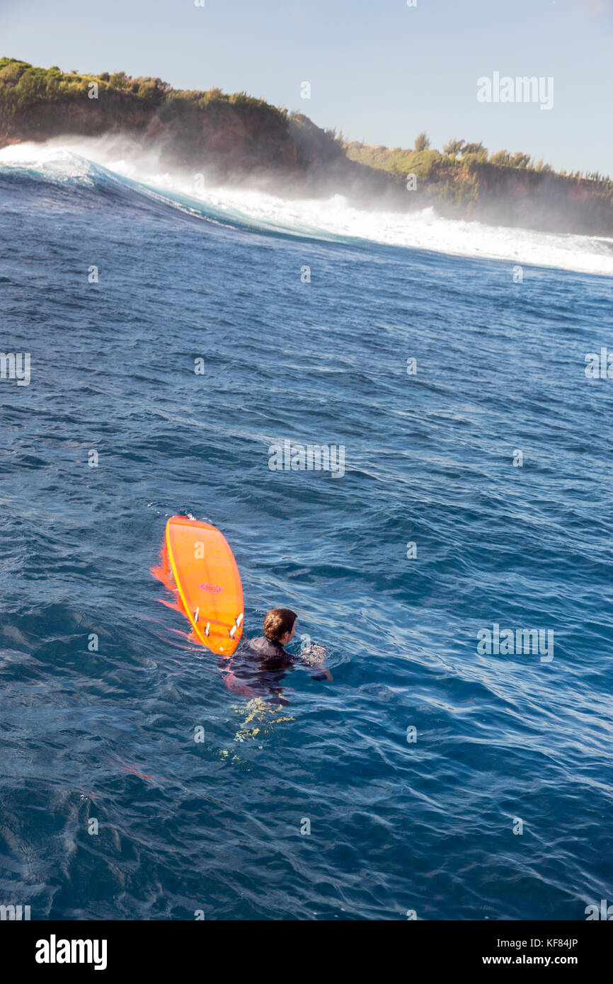 USA, HAWAII, Maui, Jaws, big wave surfer jumping in the water with his ...
