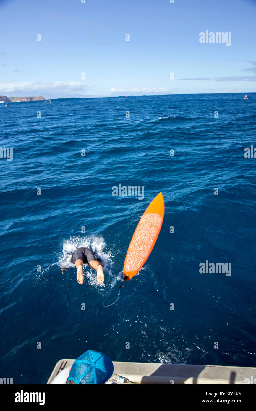 USA, HAWAII, Maui, Jaws, big wave surfer jumping in the water with his ...