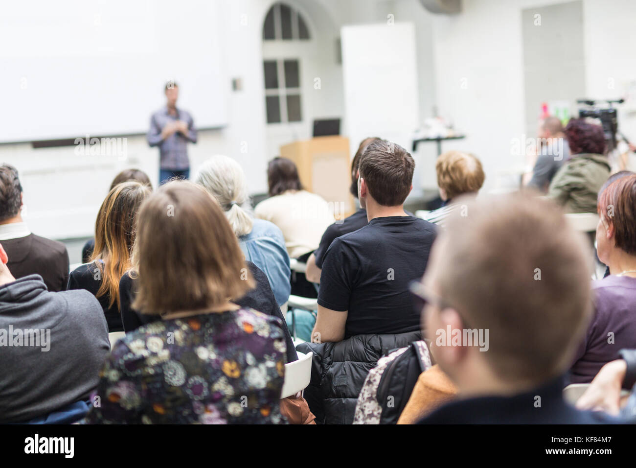 Man giving presentation in lecture hall at university Stock Photo - Alamy