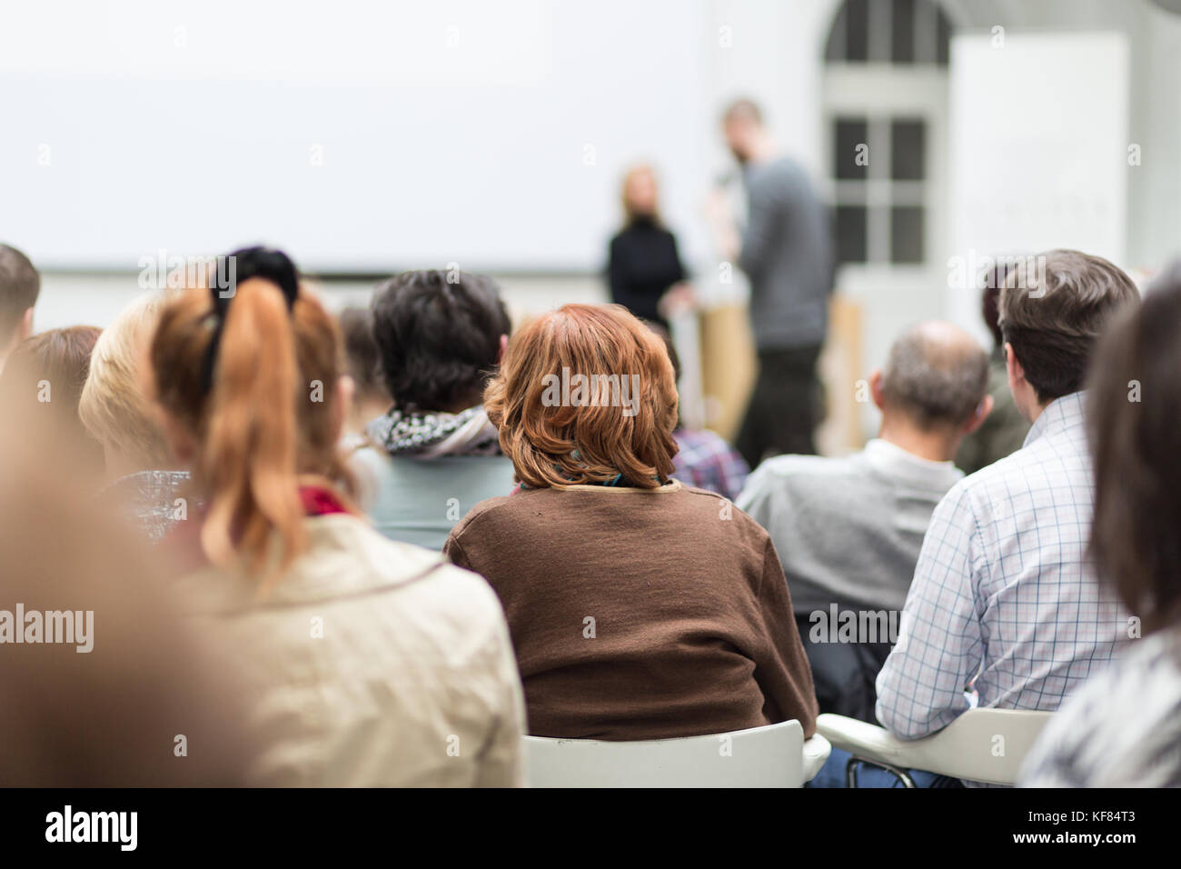 Woman giving presentation on business conference Stock Photo - Alamy