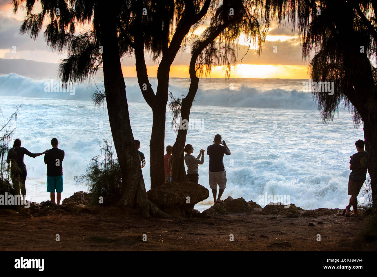 HAWAII, Oahu, North Shore, bystanders watch a big swell roll in at ...