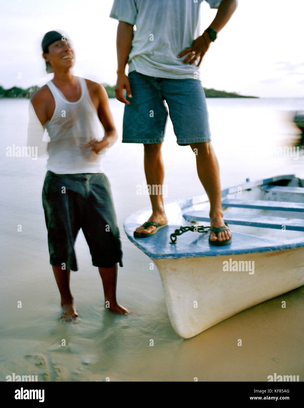 HONDURAS, Roatan, young boat drivers standing by waters edge Stock ...