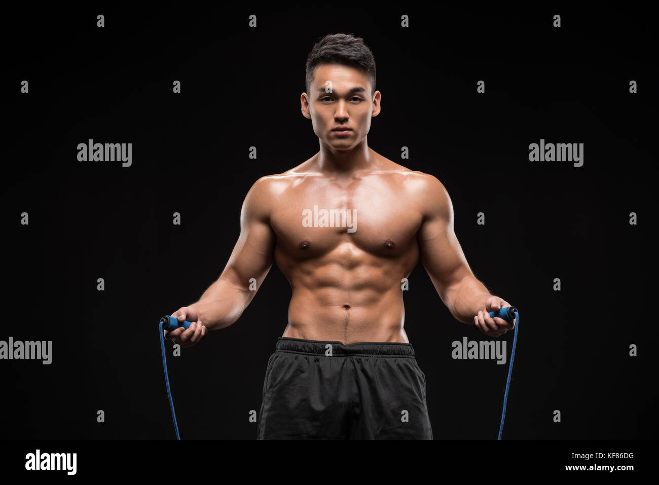 muscular man with skipping rope Stock Photo - Alamy