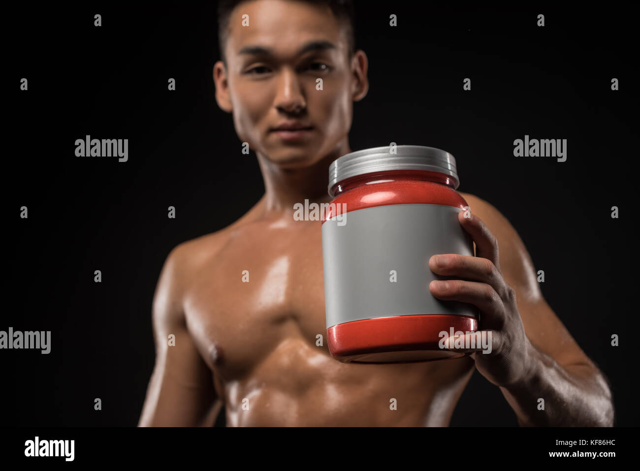 muscular man with sport nutrition Stock Photo - Alamy