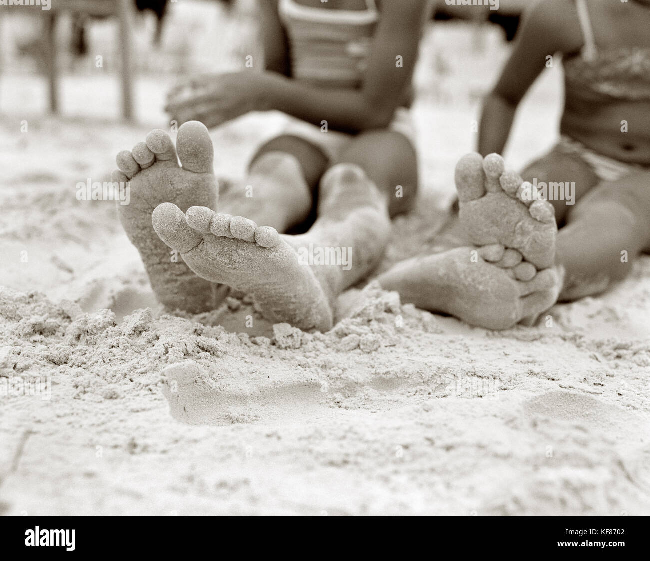 Two girls feet in sand hi-res stock photography and images - Alamy