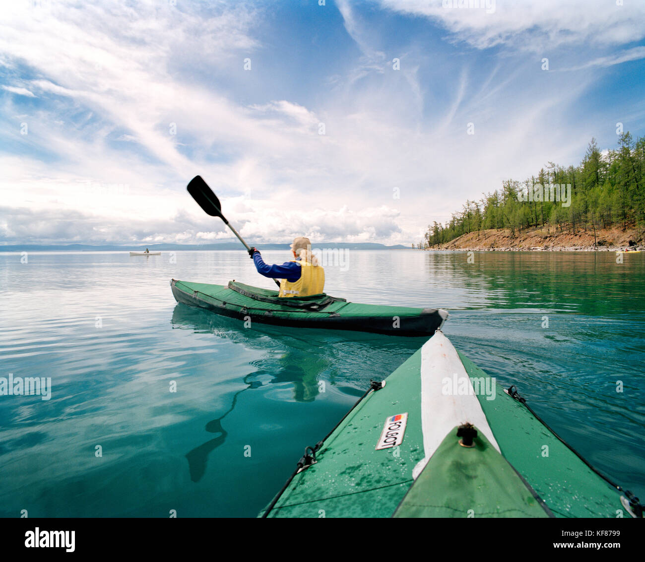 MONGOLIA, Lake Khuvsgul, the dark blue pearl, a woman kayaking ...