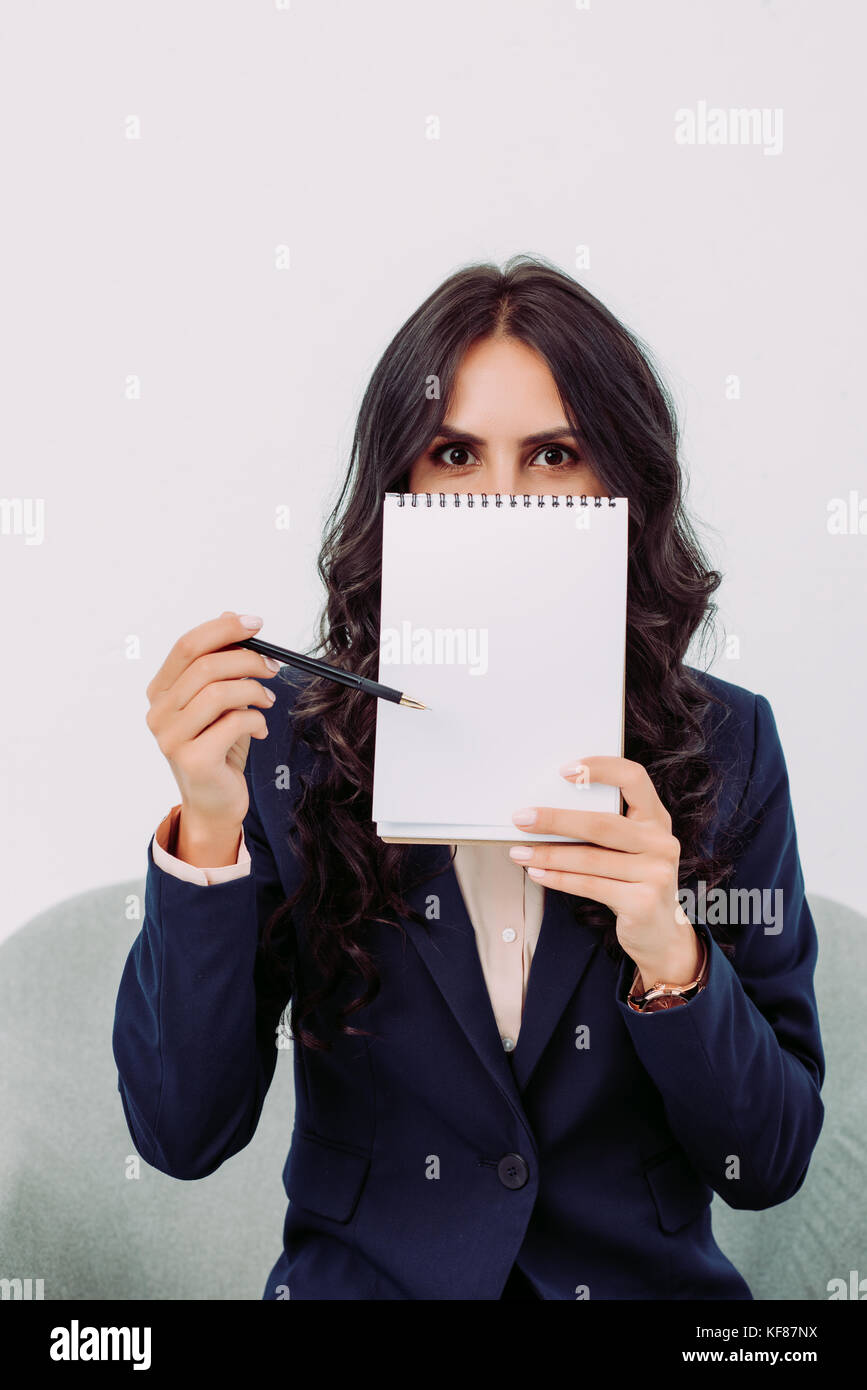businesswoman covering face with notepad Stock Photo - Alamy