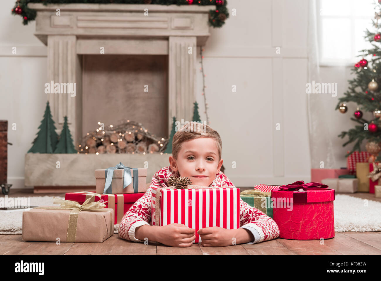 boy laying on floor with christmas gifts Stock Photo - Alamy