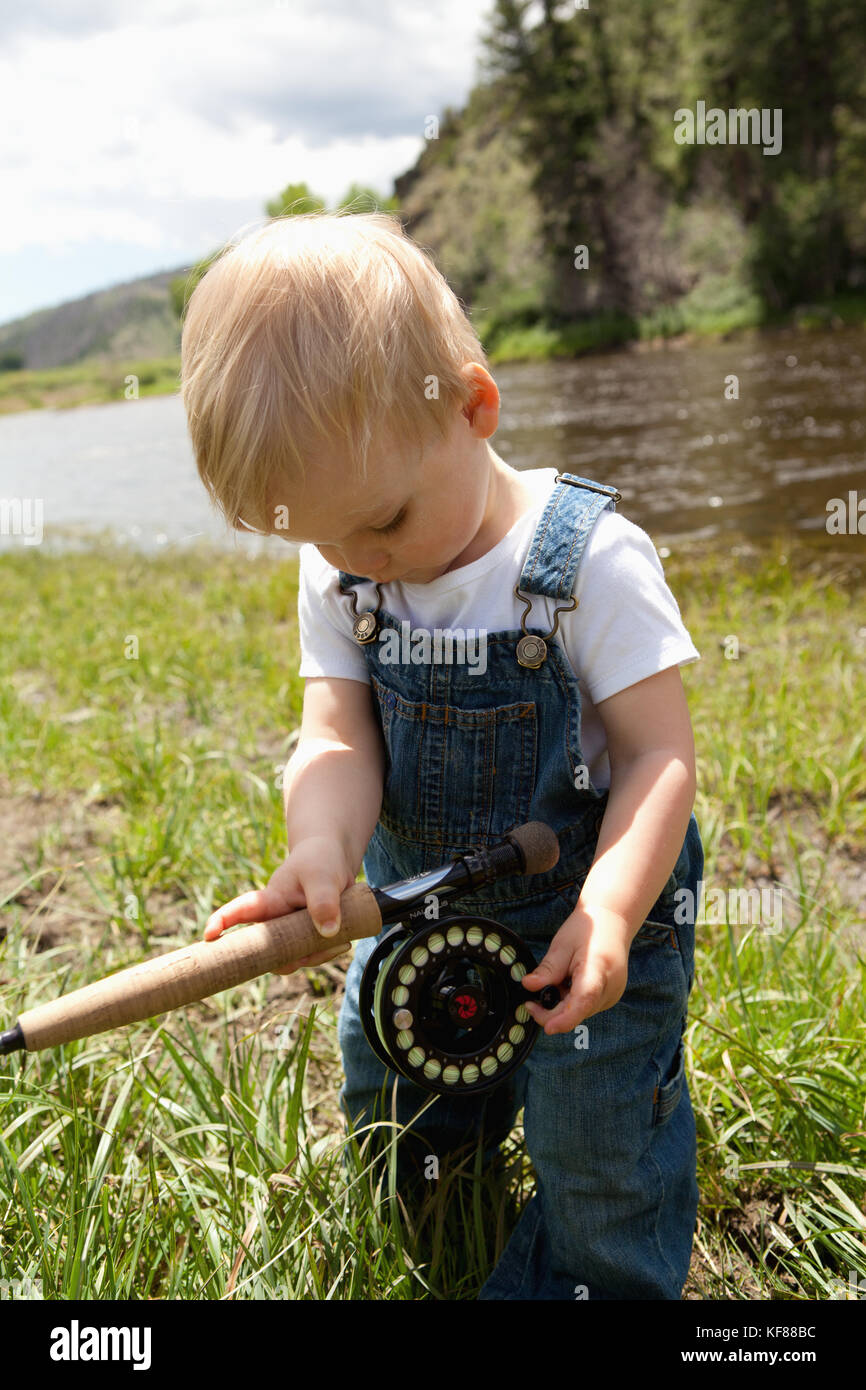 Boy fishing on riverbank hi-res stock photography and images - Alamy