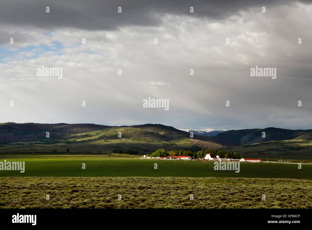 USA, Wyoming, Encampment, Big Creek Ranch is lit with early morning ...