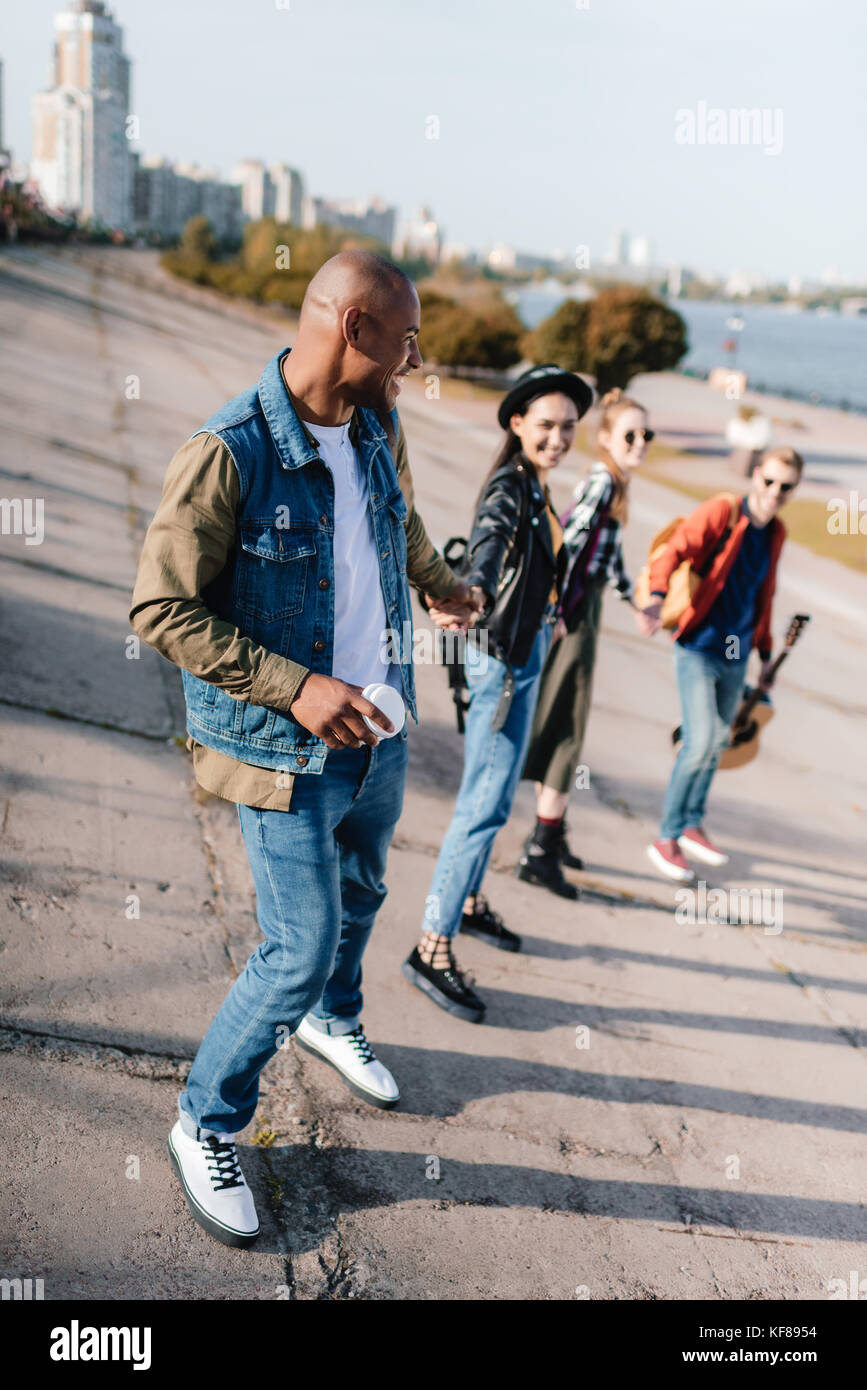 multicultural friends holding hands Stock Photo - Alamy