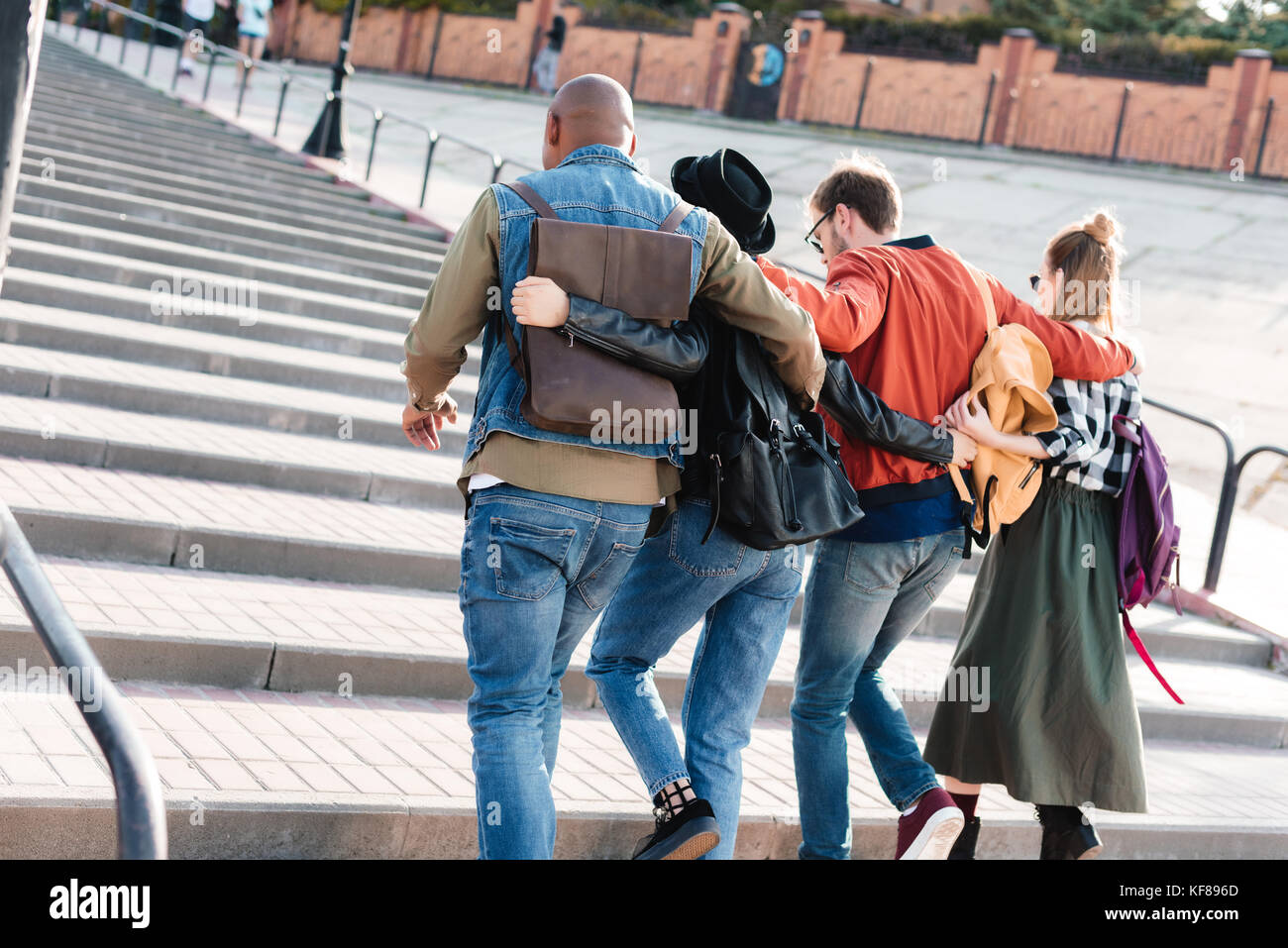 multicultural friends walking on street Stock Photo - Alamy