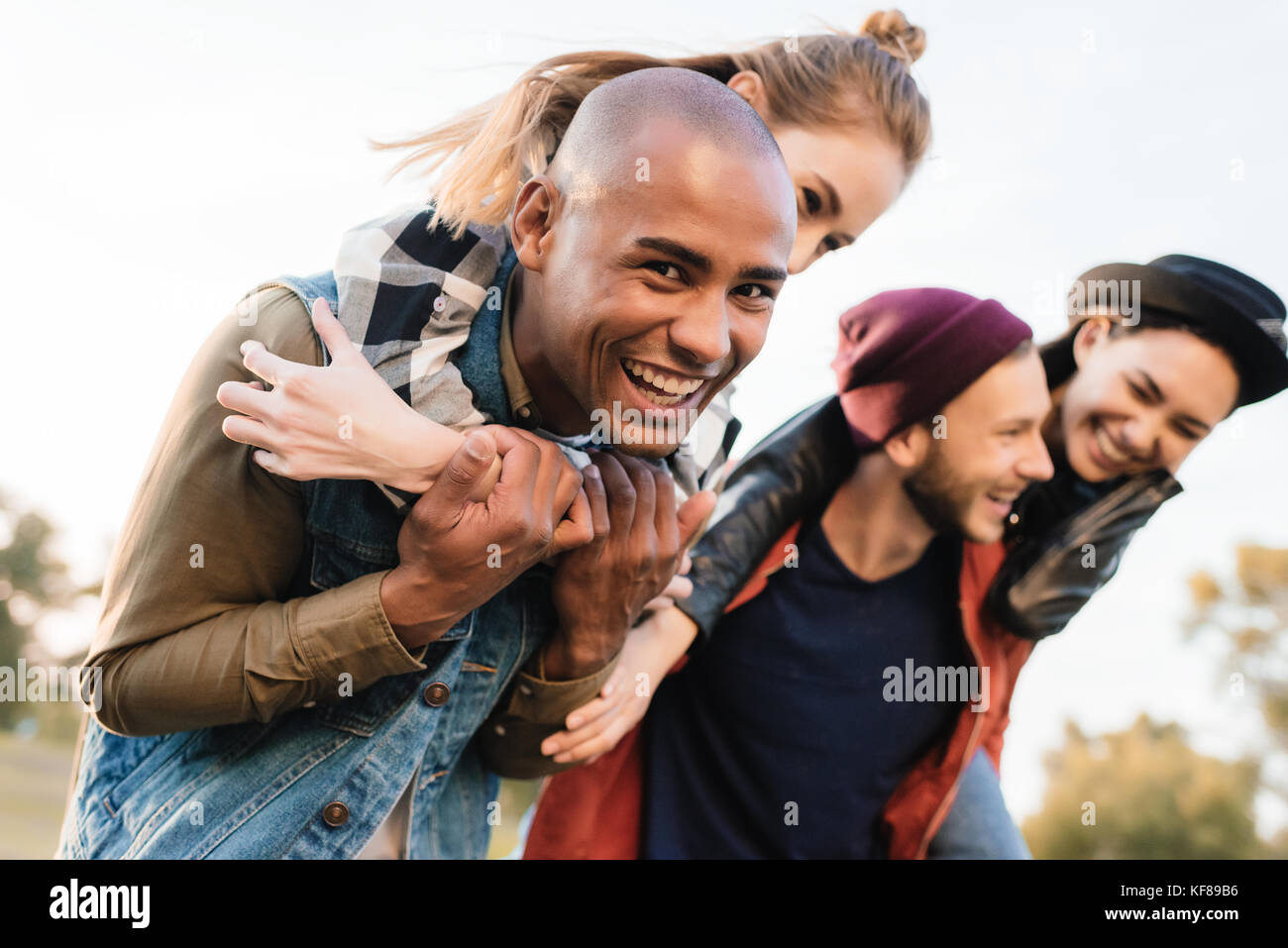 happy couples piggybacking together Stock Photo - Alamy